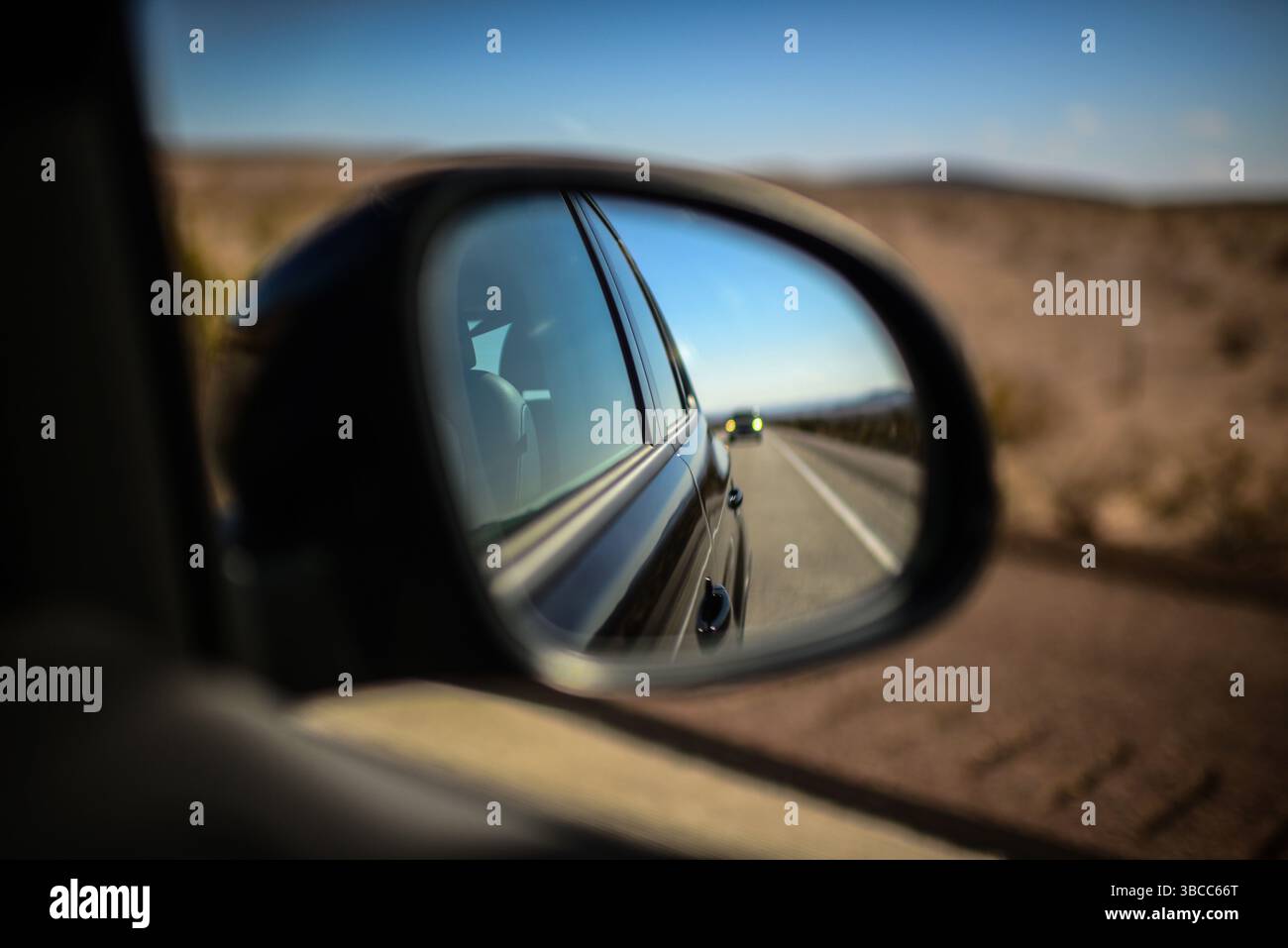 View of an Arizona highway through a car's rearview mirror Stock Photo ...