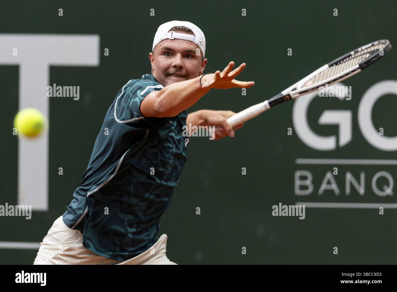 Dominic Stricker of Switzerland, returns a ball to Cameron Norrie of ...