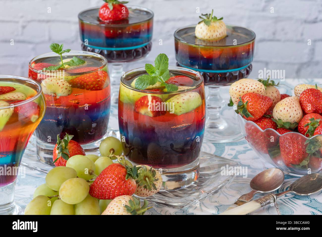 Homemade layered rainbow fruit jelly with fresh fruit Stock Photo - Alamy
