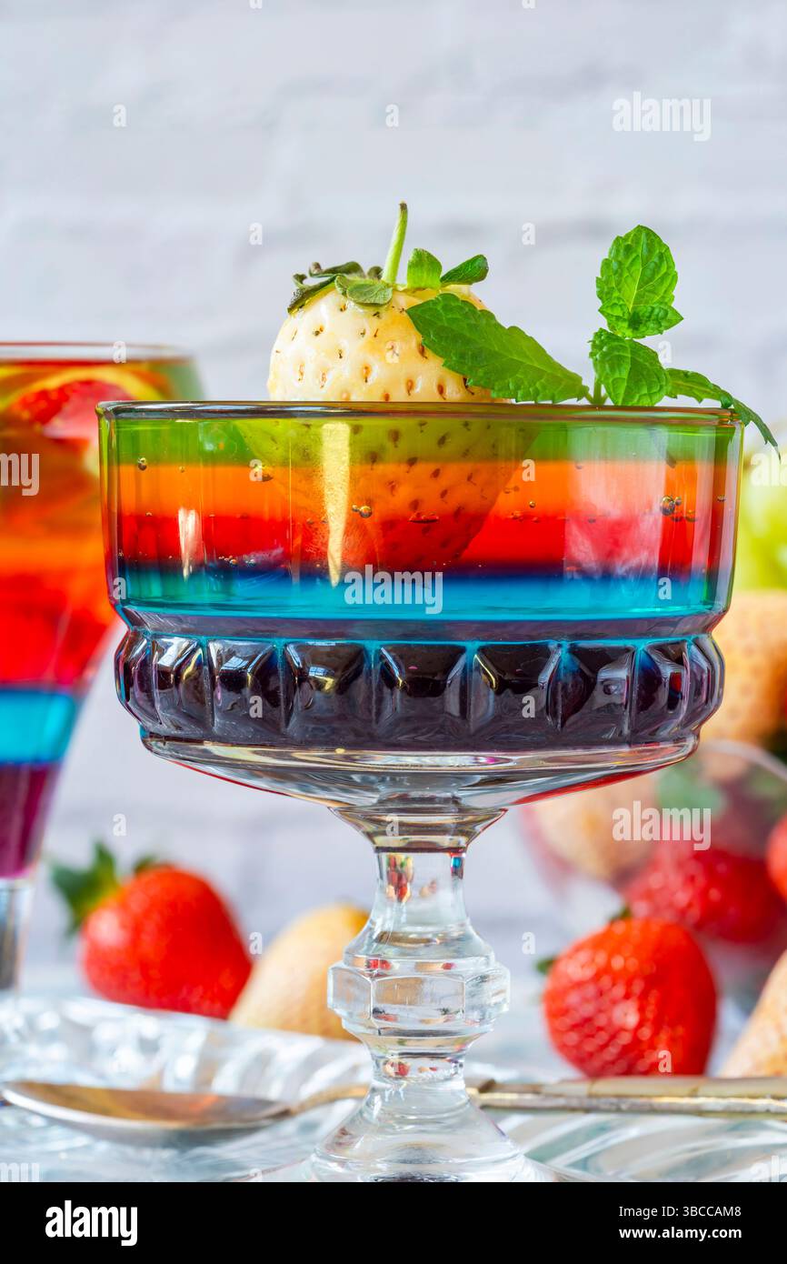 Homemade layered rainbow fruit jelly with fresh fruit Stock Photo - Alamy