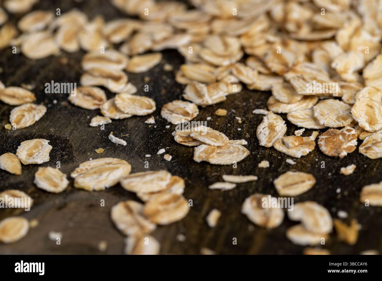 scattered oat flakes from which porridges and other healthy dishes are ...