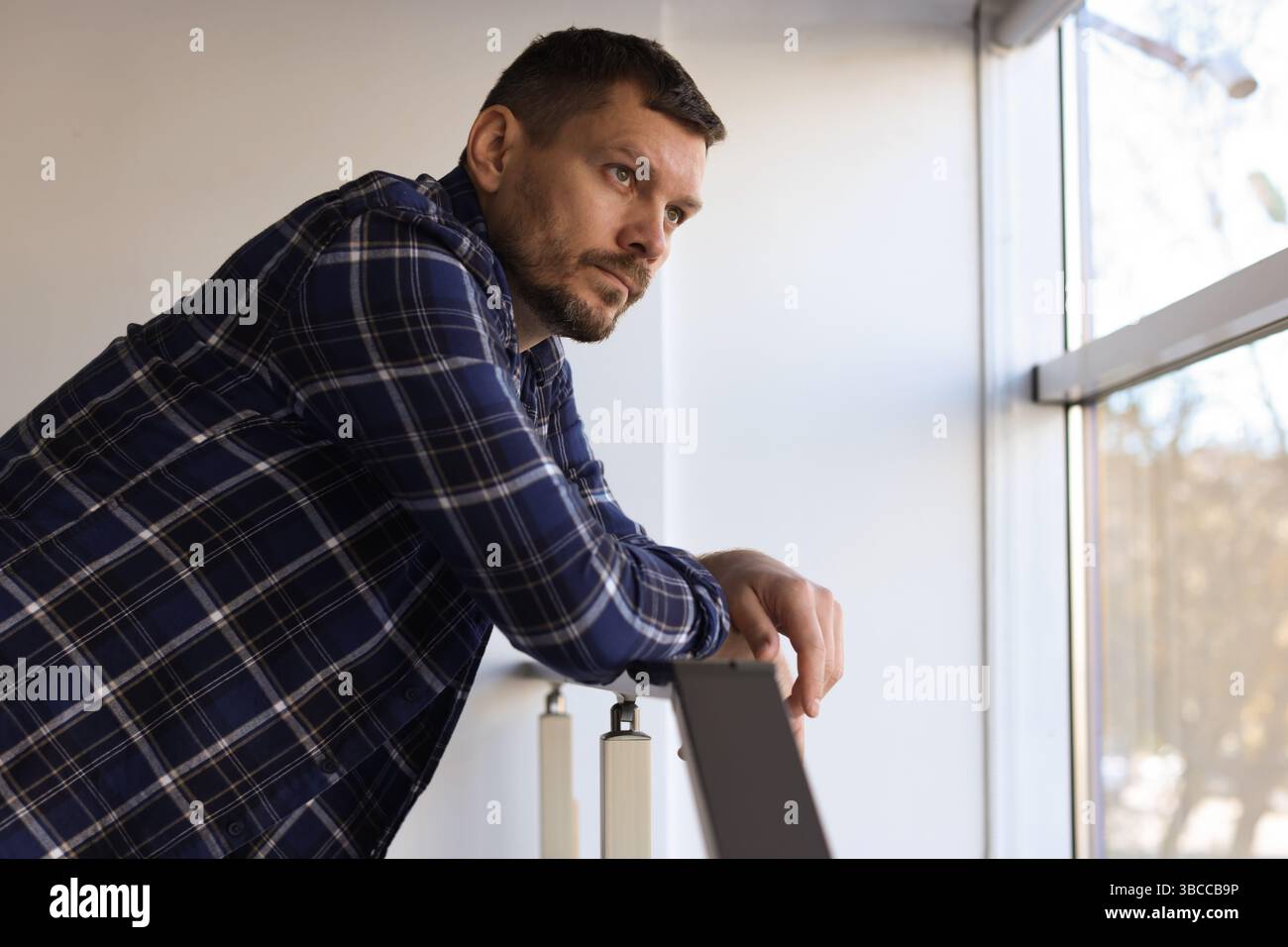 Depressed man near window in building. Mental health problem Stock ...