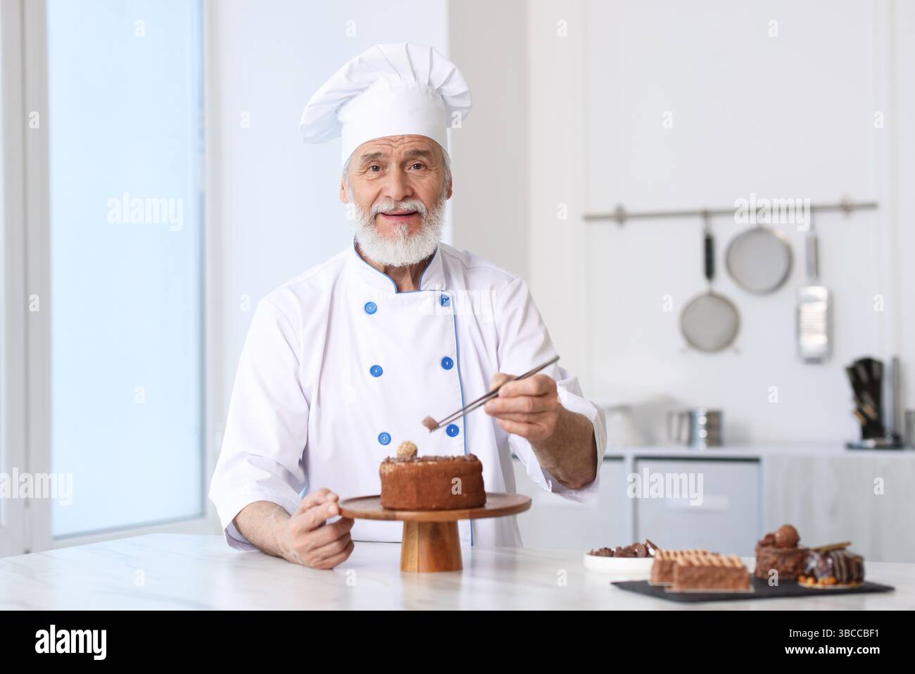 Elderly pastry chef decorating hi-res stock photography and images - Alamy