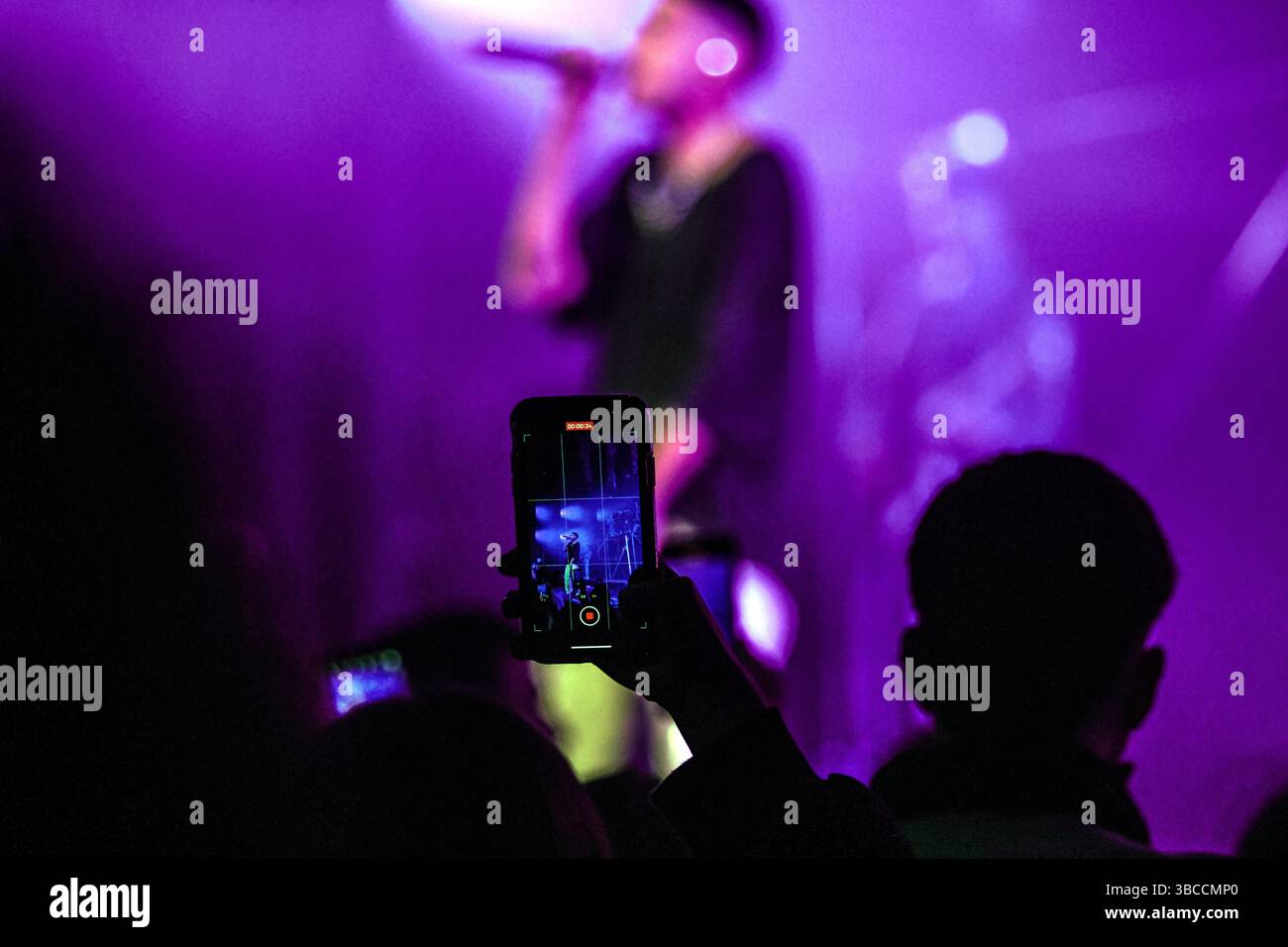Recording of a concert with the cellphone from the audience Stock Photo ...
