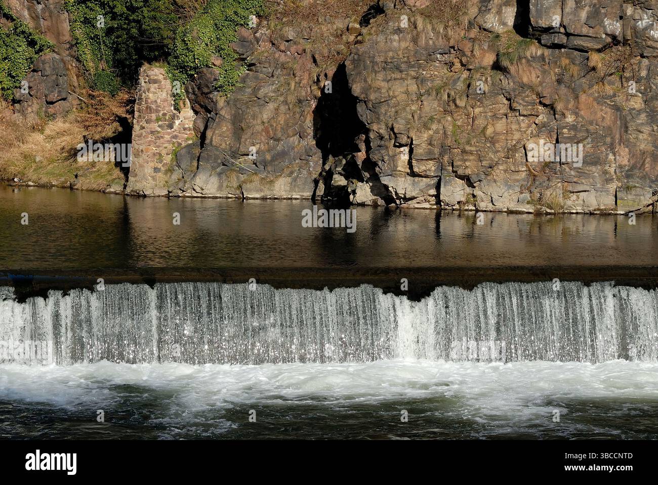 Small waterfall over a weir with light reflections, Germany Stock Photo ...