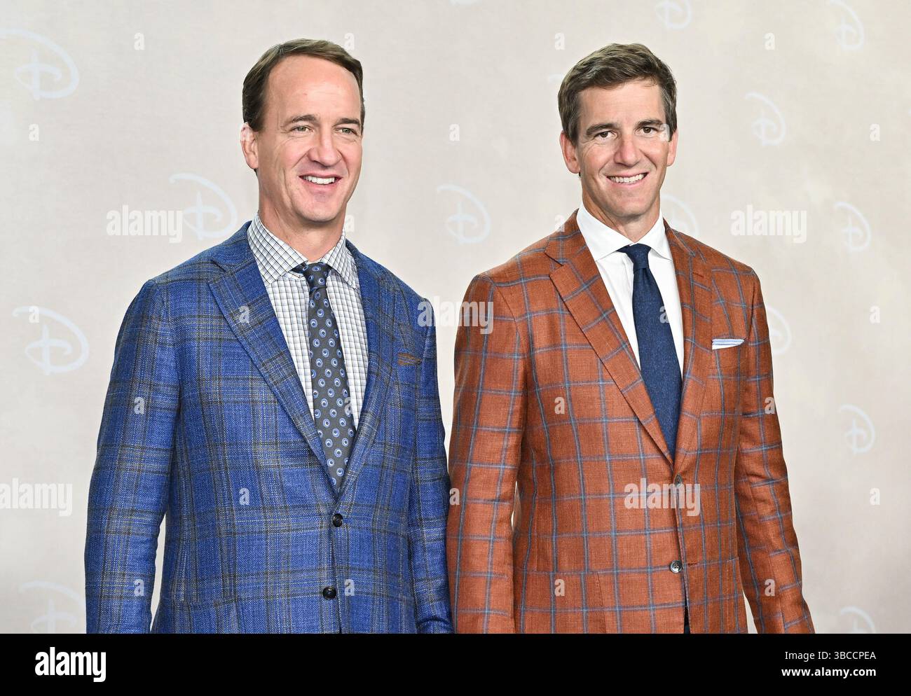 Peyton Manning, left, and Eli Manning attend the Disney 2025 Upfront ...