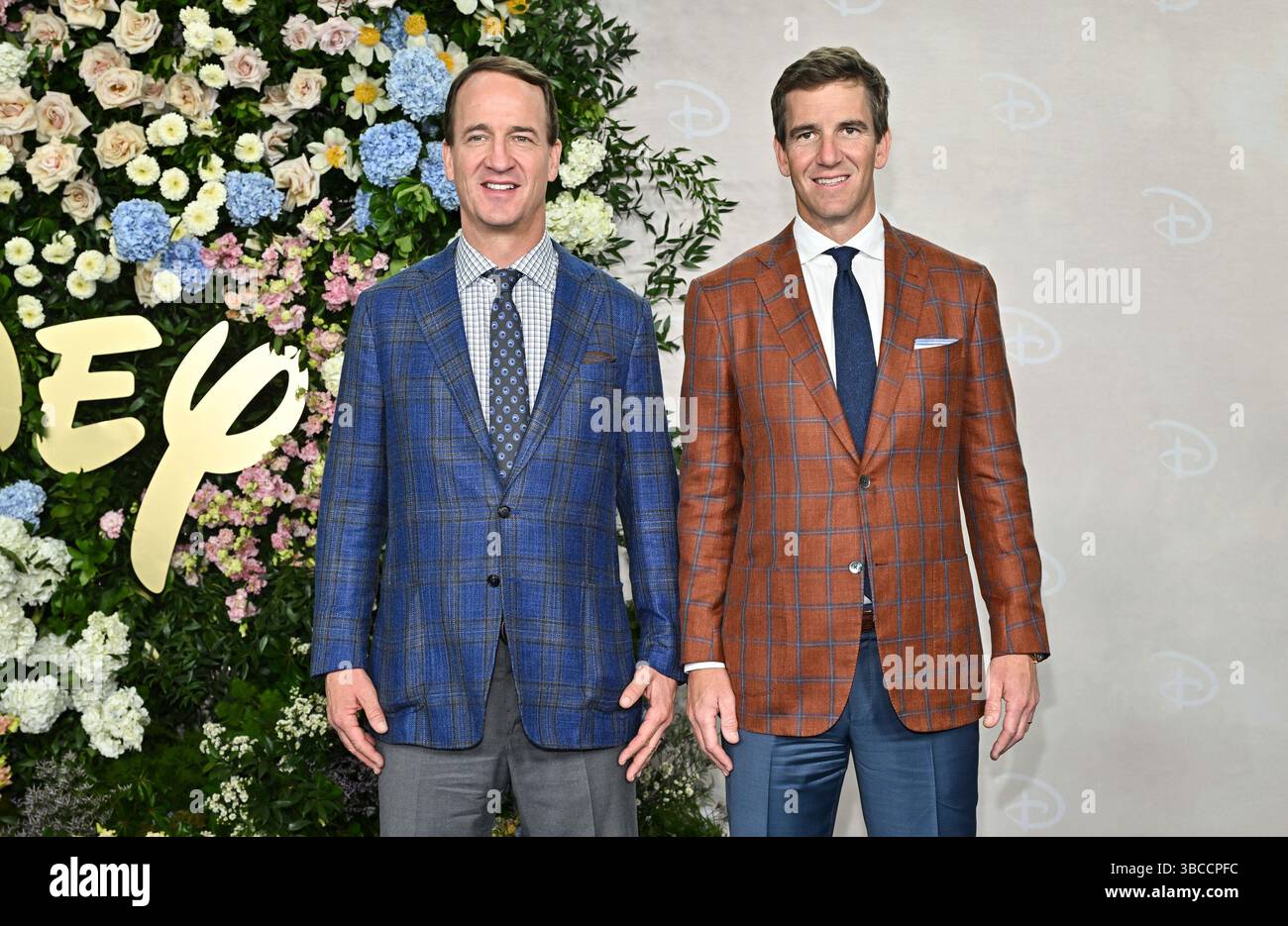 Peyton Manning, left, and Eli Manning attend the Disney 2025 Upfront ...