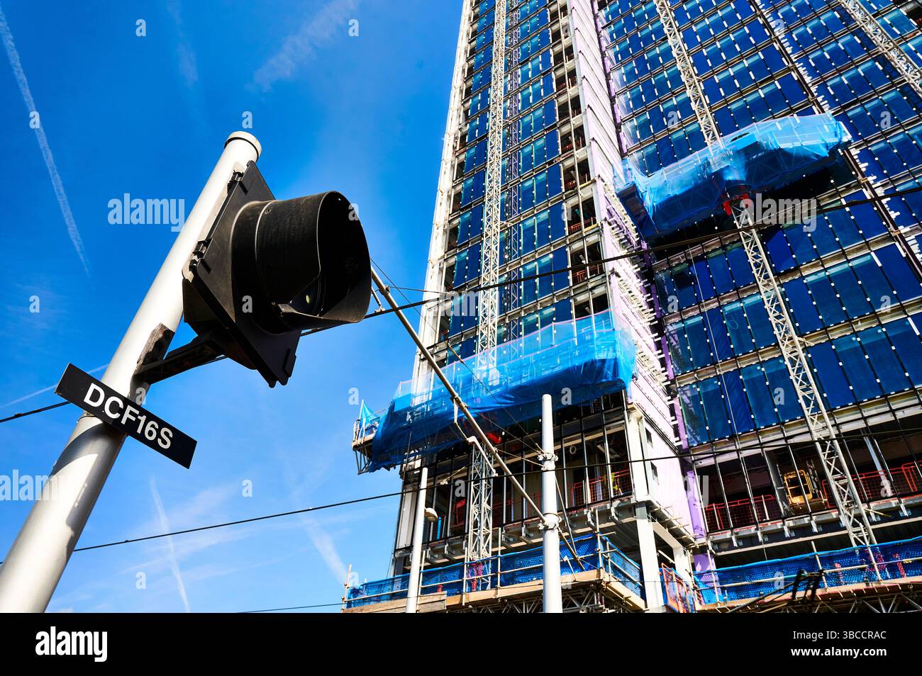 Tramway signal next to tower block under construction,Manchester,UK ...