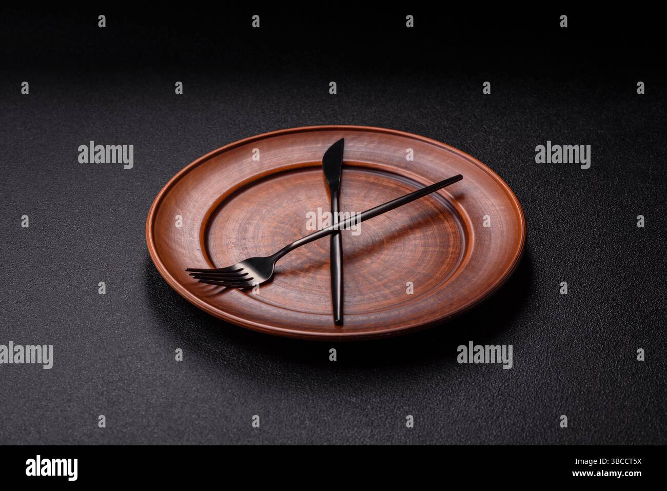Empty plate with devices in the form of clock hands as a conceptual ...
