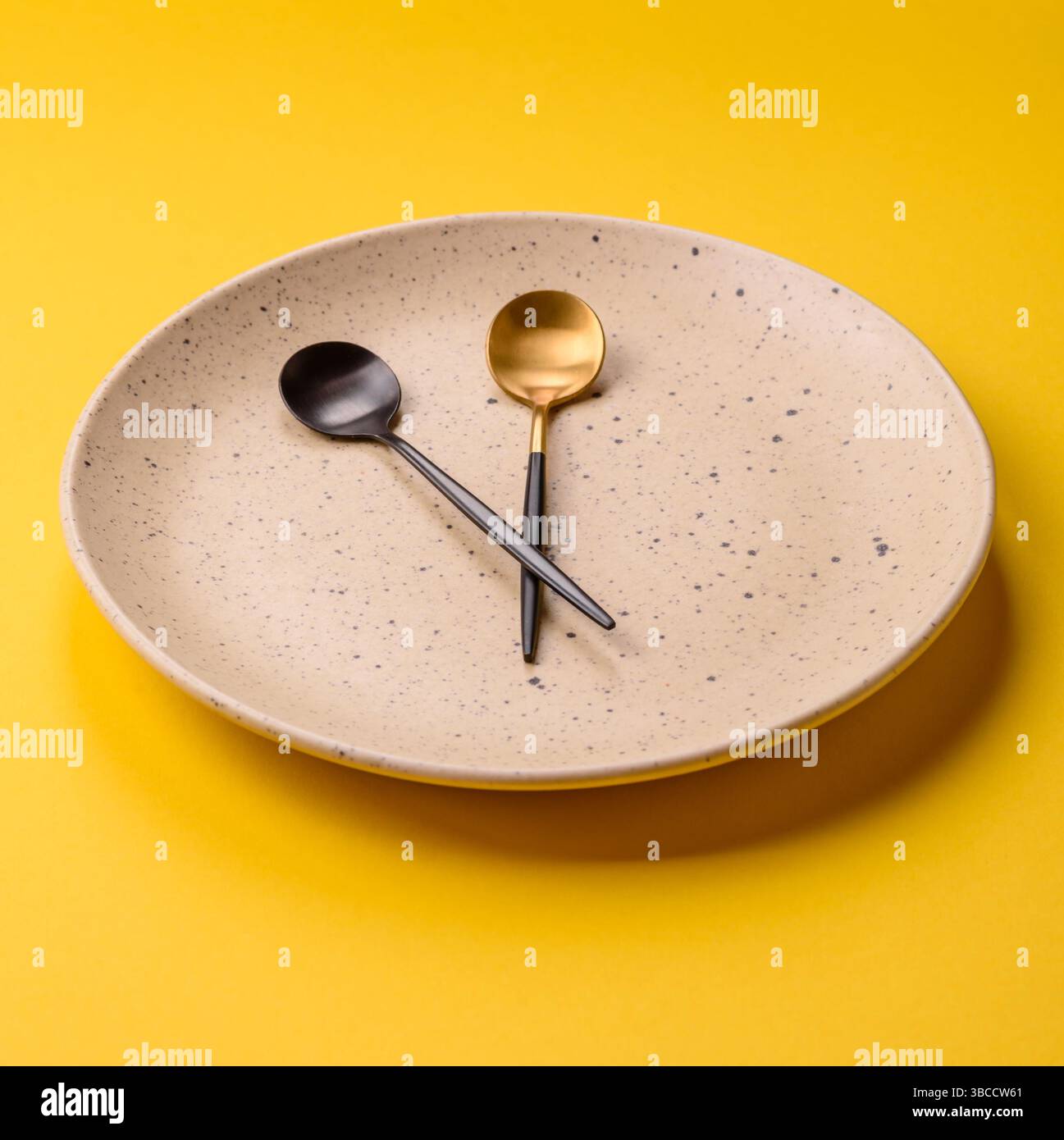 Empty plate with devices in the form of clock hands as a conceptual ...