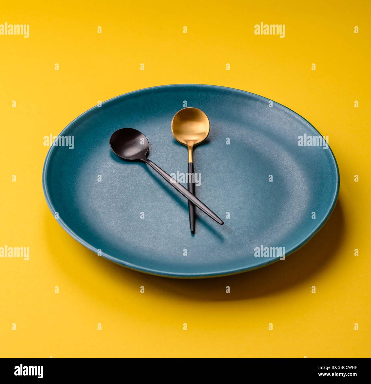 Empty plate with devices in the form of clock hands as a conceptual ...