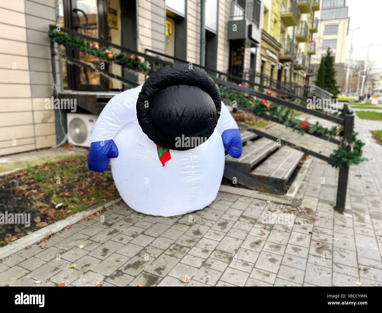 Broken life-sized snowman mascot decorates city center during Christmas ...