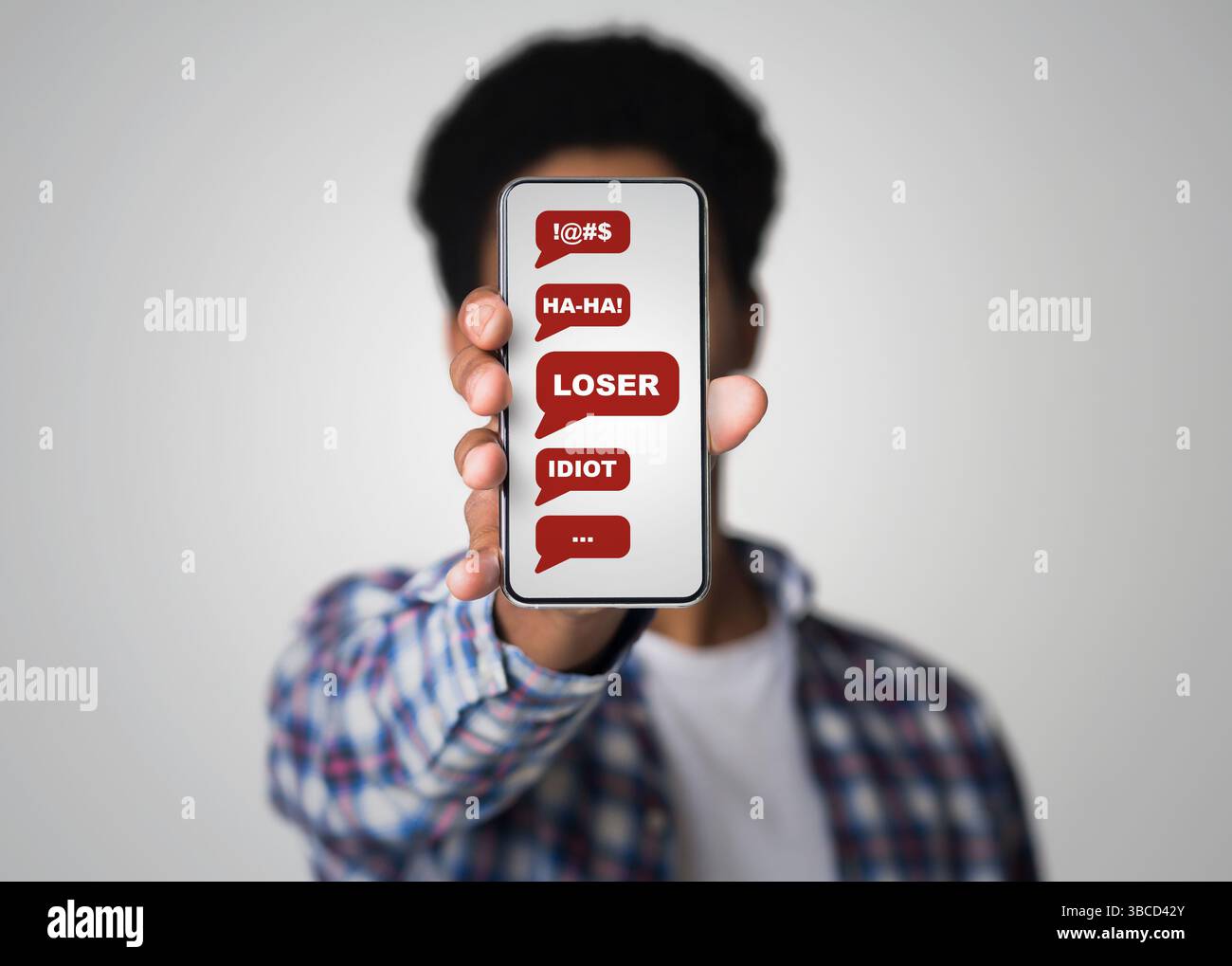 Cyberbullying concept. African American guy showing smartphone with ...