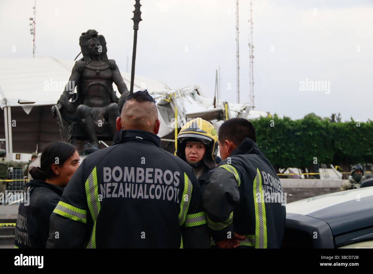 Firefighters guard the zone where a structure collapsed because strong ...