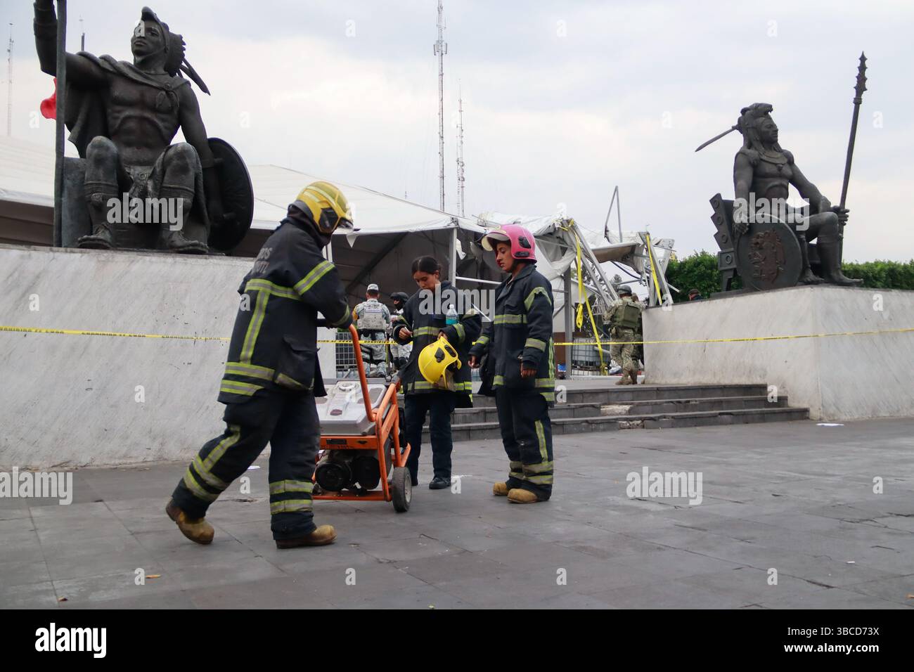 Firefighters guard the zone where a structure collapsed because strong ...