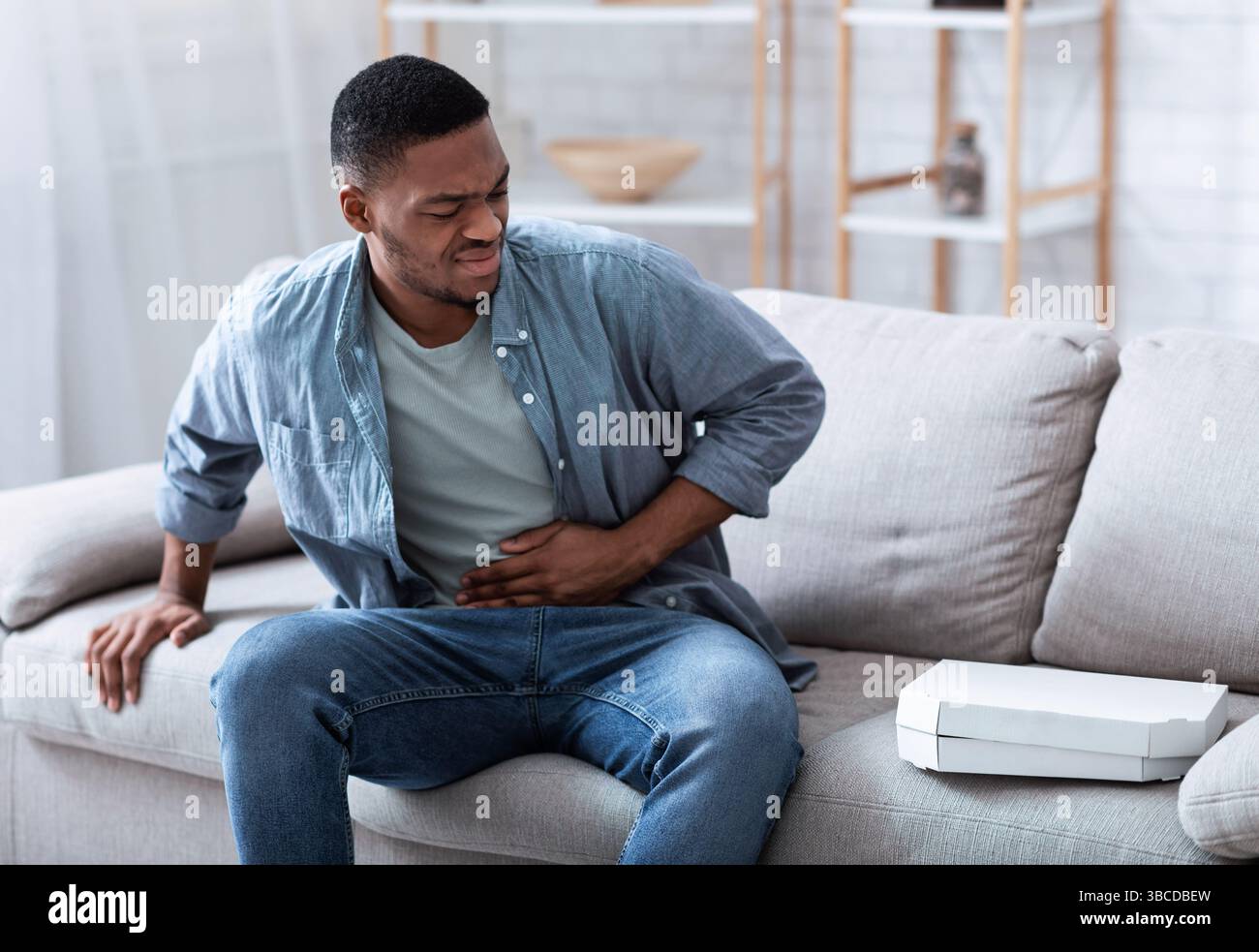African American Guy Having Stomachache After Eating Pizza At Home ...