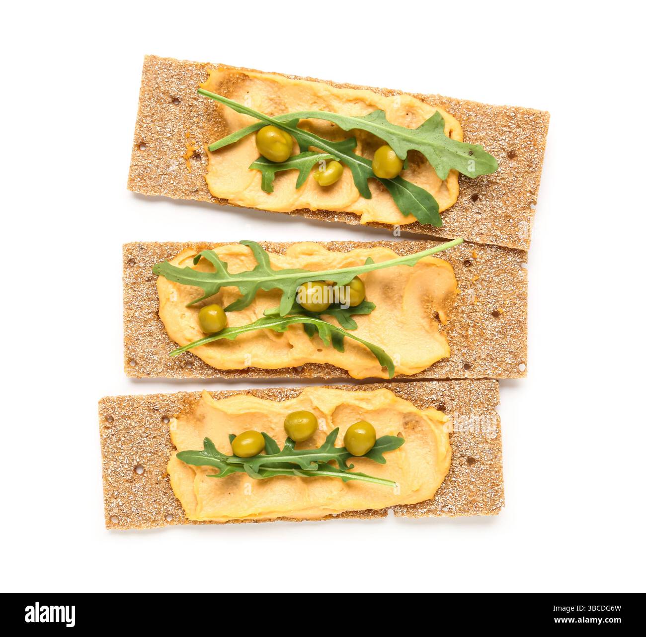 Crispbreads with tasty hummus and arugula on white background Stock ...
