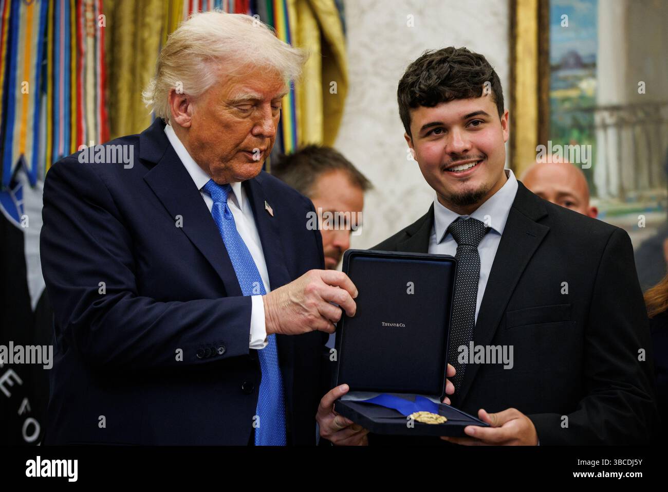 President Donald Trump presents a Medal of Sacrifice to Cameron Paez in ...