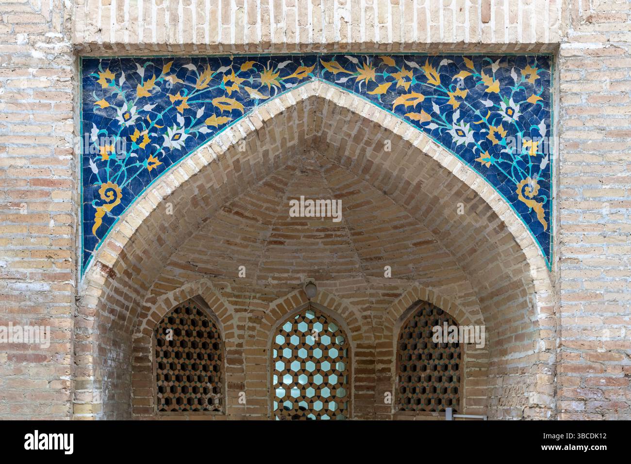 Star-shaped blue and gold tiles frame the arch of Nadir Divan Begi ...
