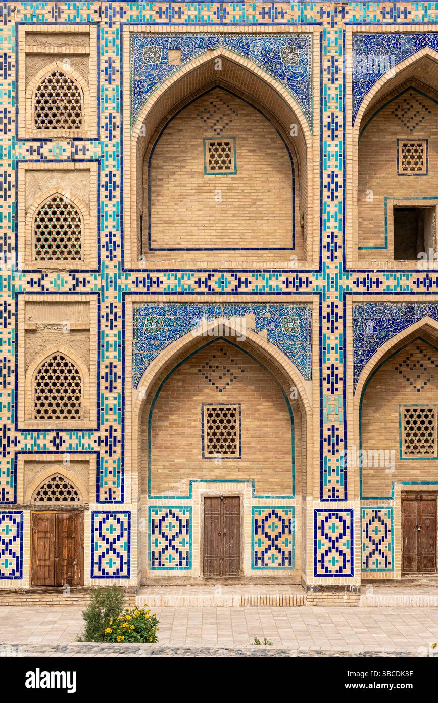 The colorful facade of Ulugbek Madrasah in Bukhara, Uzbekistan, is ...