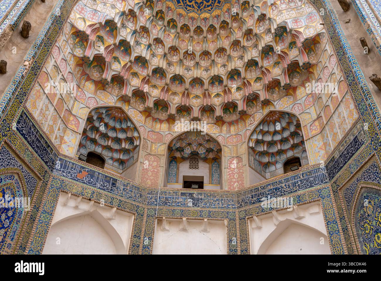 Muqarnas honeycomb vaulting with painted detail covers the iwan of ...