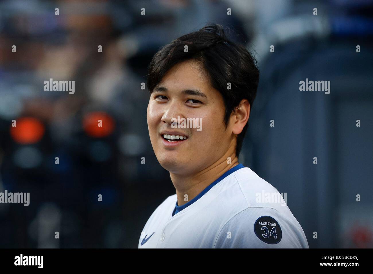 Shohei Ohtani #17 of the Los Angeles Dodgers smiles in the dugout ...