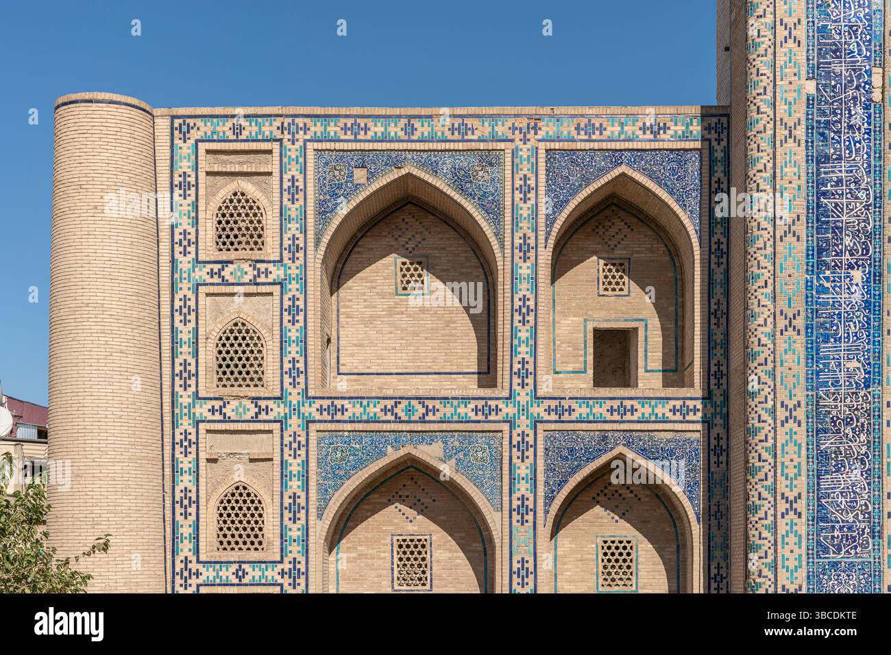 Rows of pointed arches and blue tile bands highlight Ulugbek Madrasah ...