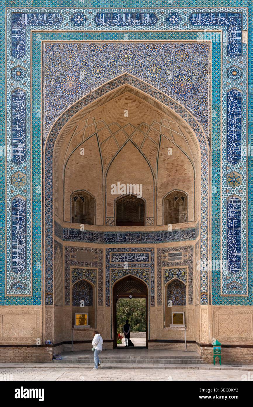 A tall pointed arch with blue tiles decorates the facade of Kalyan ...
