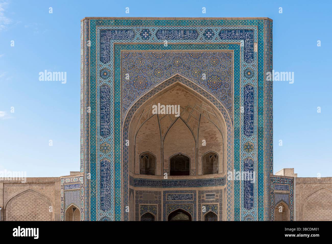A monumental portal with blue tiles and muqarnas marks Kalyan Mosque in ...