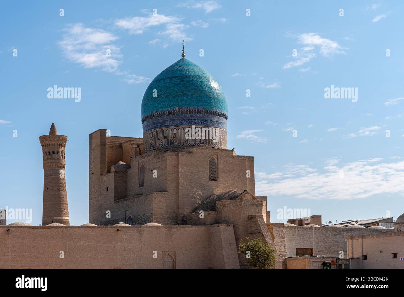A turquoise dome and brick walls stand at Kalyan Mosque in Bukhara ...