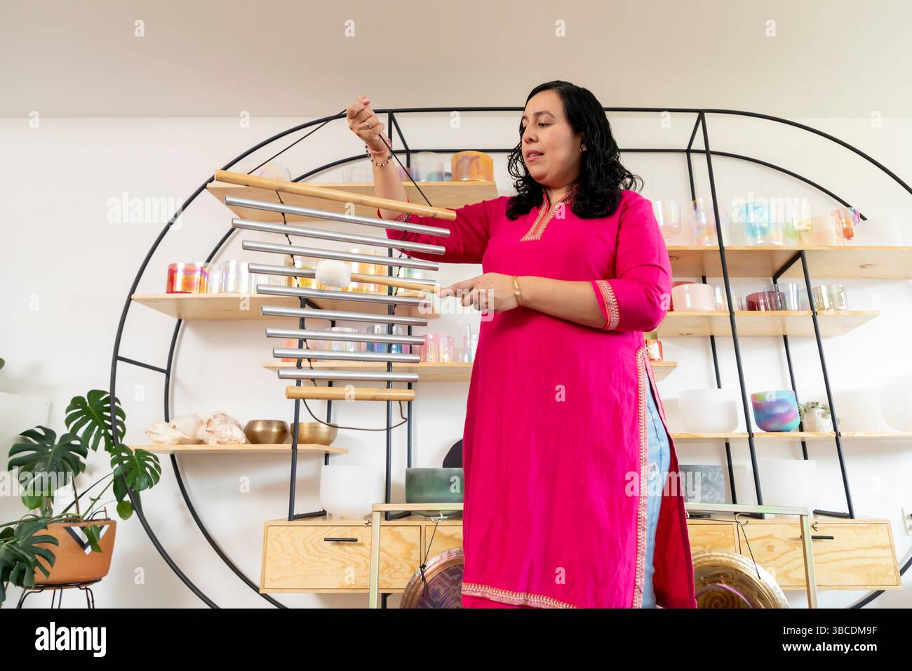 Mexican musician playing bar chimes in music studio with sound healing ...