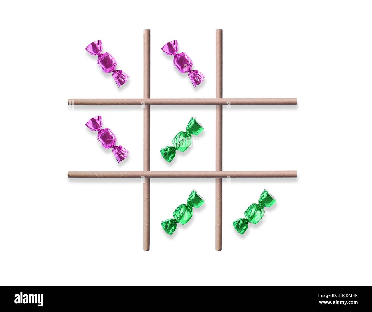 Tic-tac-toe game made of different candies and drinking straws on white ...