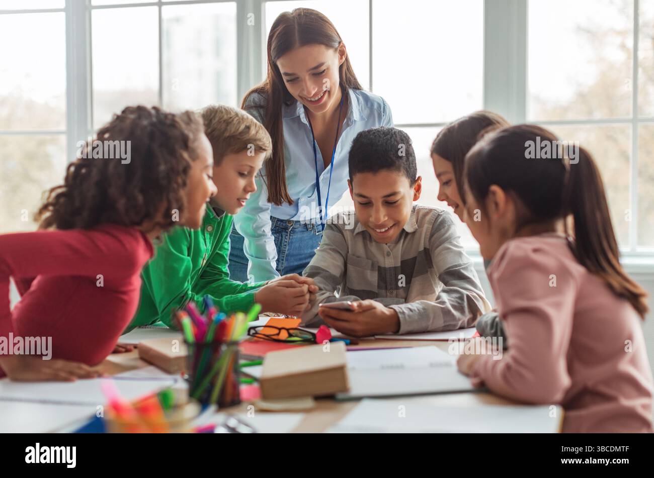 Multiethnic School Kids And Teacher Using Smartphone In Modern ...