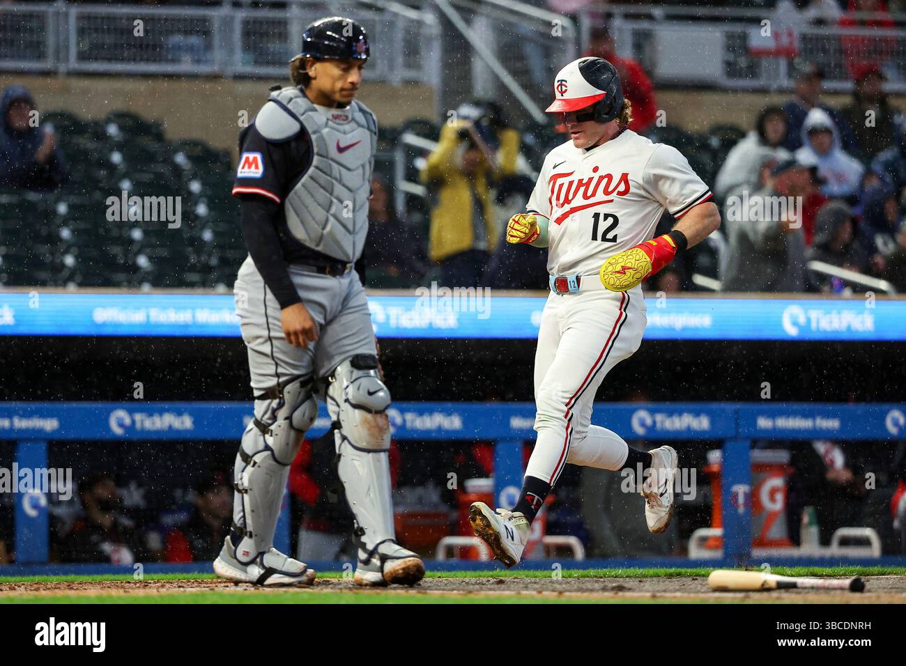 Minnesota Twins' Harrison Bader (12) scores on a double hit by Willi ...