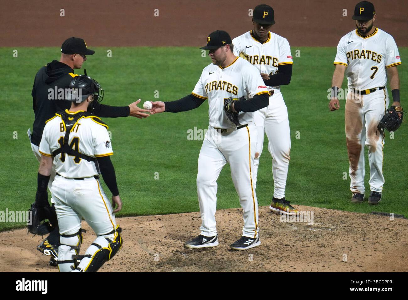 Pittsburgh Pirates pitcher David Bednar, center, hands the baseball to ...
