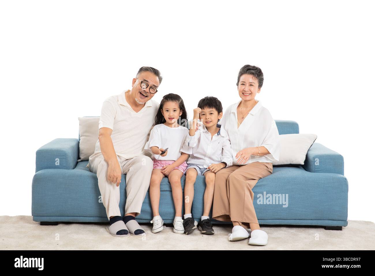 four generations (grandparents and grandchildren) watching TV on the sofa Stock Photo - Alamy