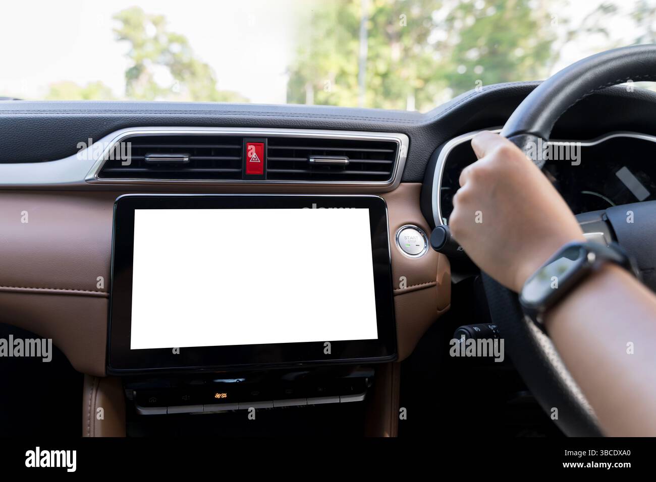 Closeup of a car dashboard with a blank touchscreen and hand on the ...