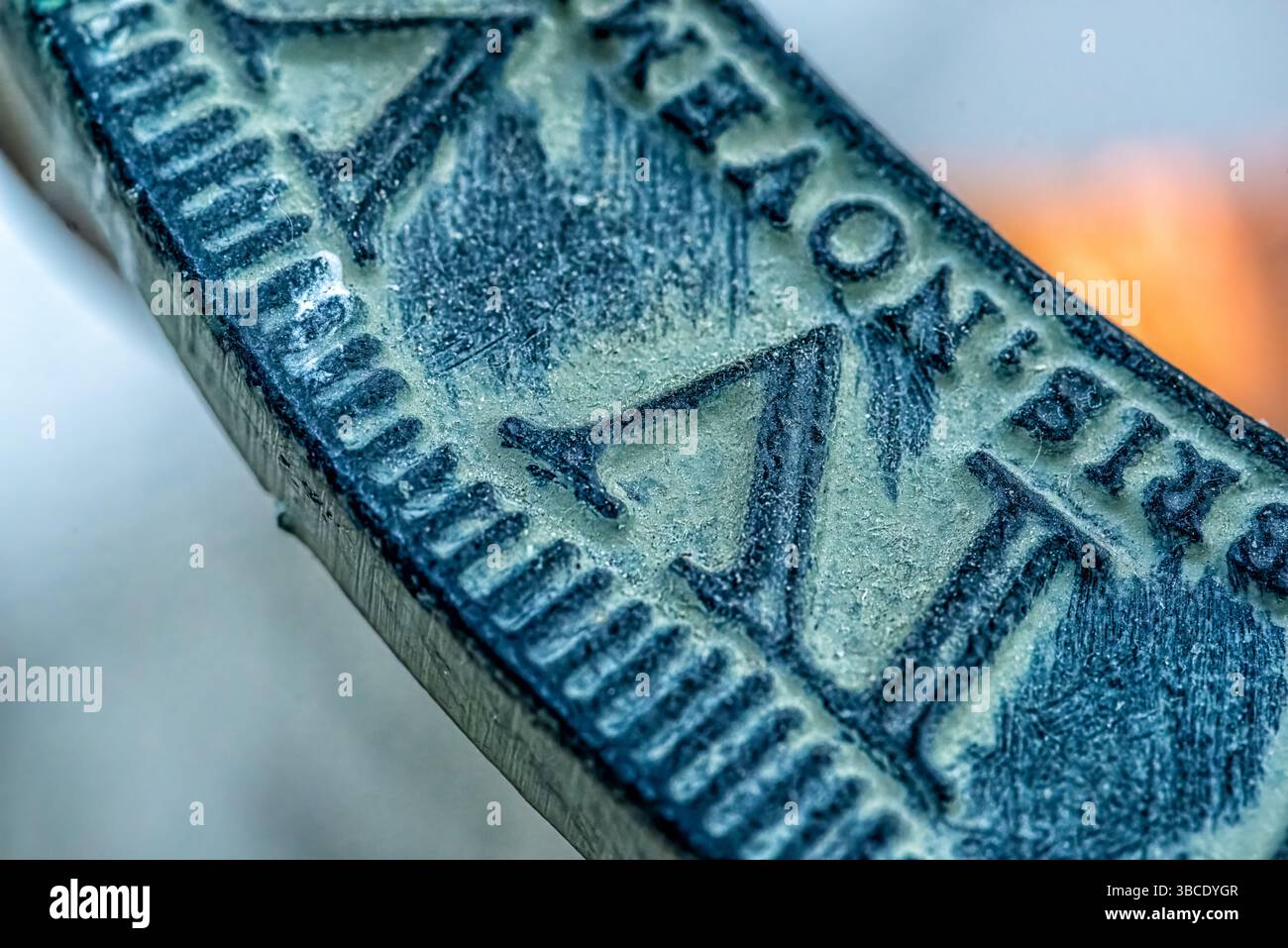 Macro view of Roman numeral VI on a weathered metal sundial ring ...