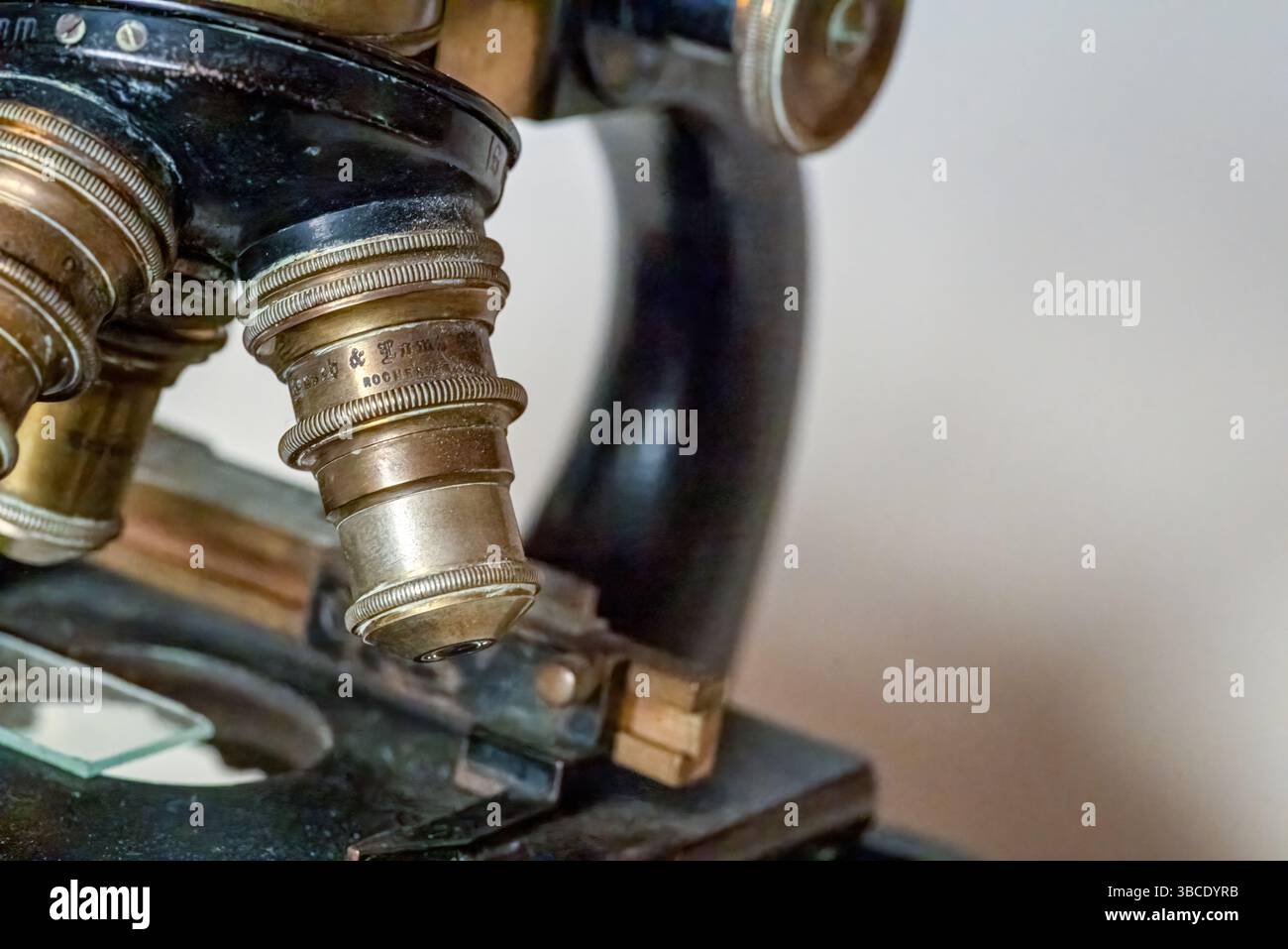 Side view of a vintage microscope with brass objective lenses and a ...