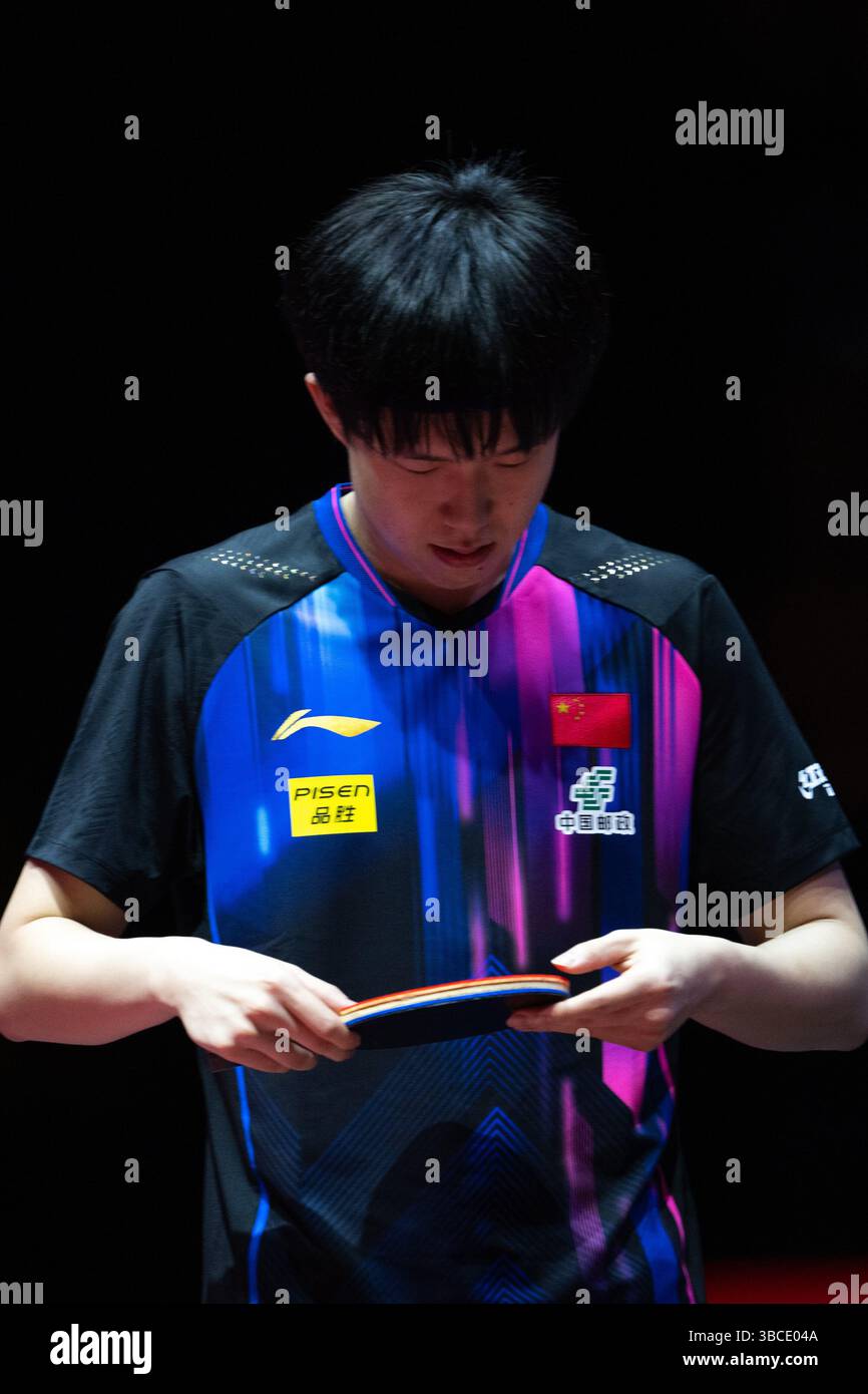 Doha, Qatar. 19th May, 2025. Wang Chuqin checks his racket before the ...