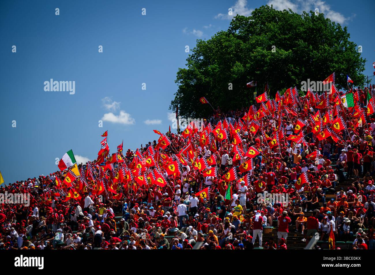 Imola, Italy. 18th May, 2025. Fans wave with Ferrari flags during the ...