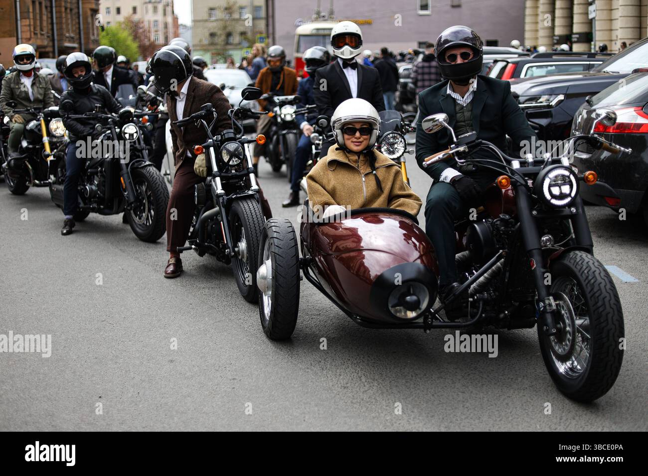 Participants ride their motorcycles during the start of the ...