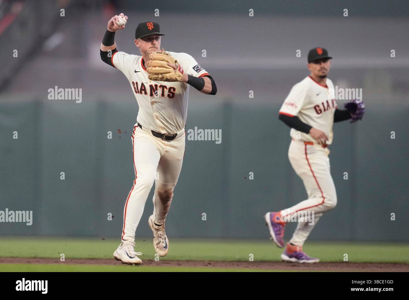 San Francisco Giants second baseman Tyler Fitzgerald, left, throws out ...