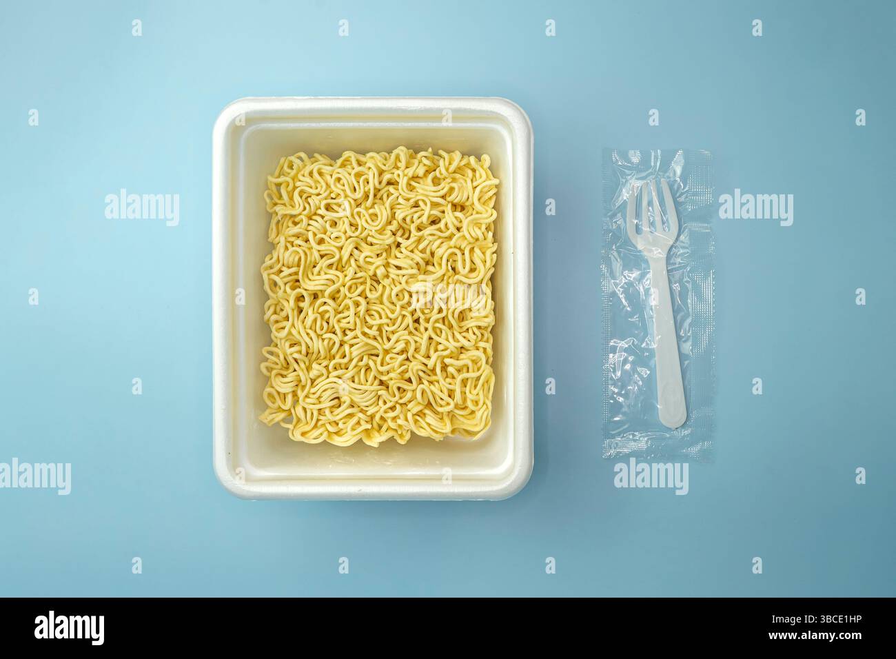 White box of noodles on an blue background, fast cheap food. Chinese ...