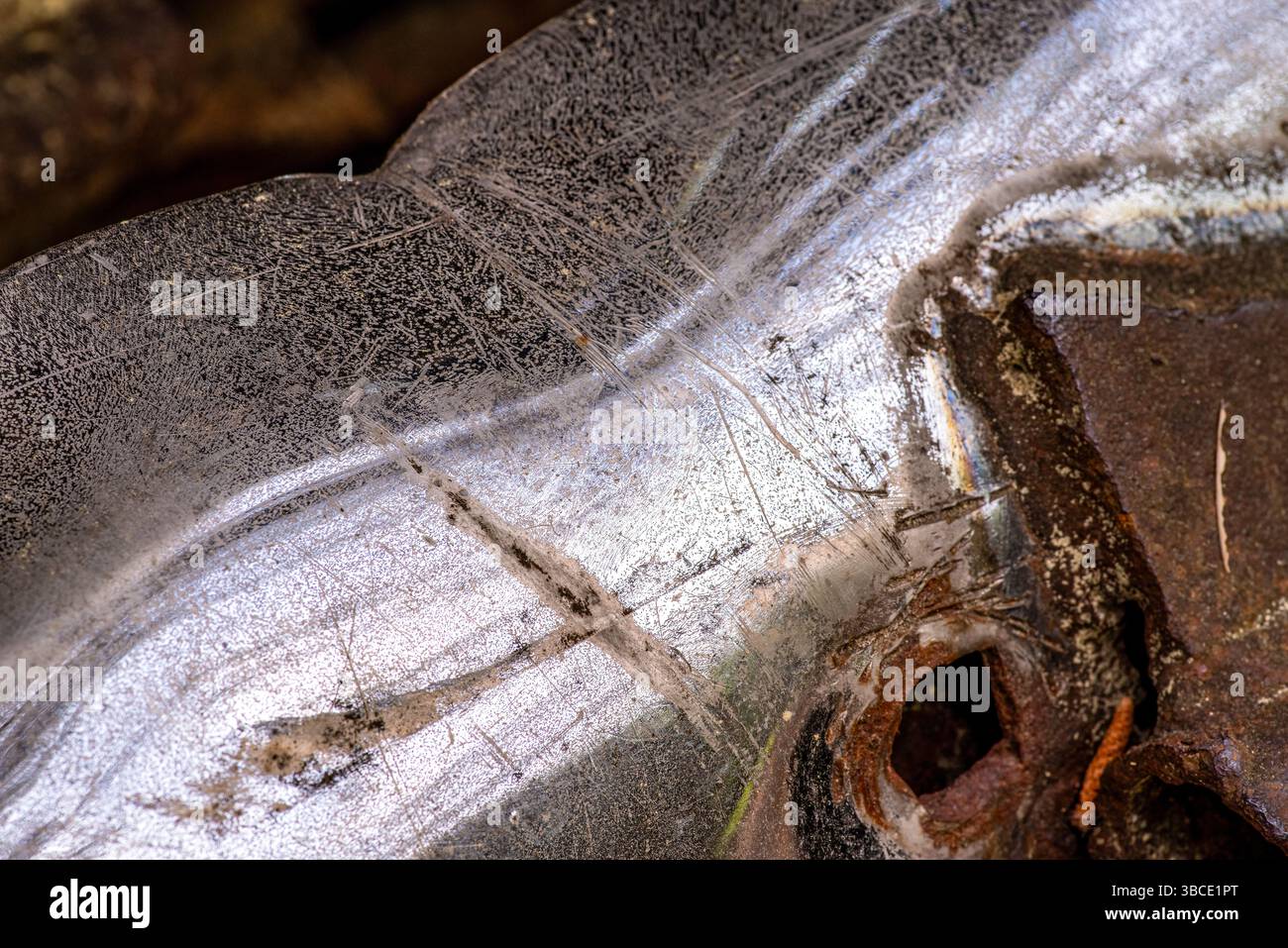 Extreme close-up of a scratched metal surface with rust, dirt, and ...