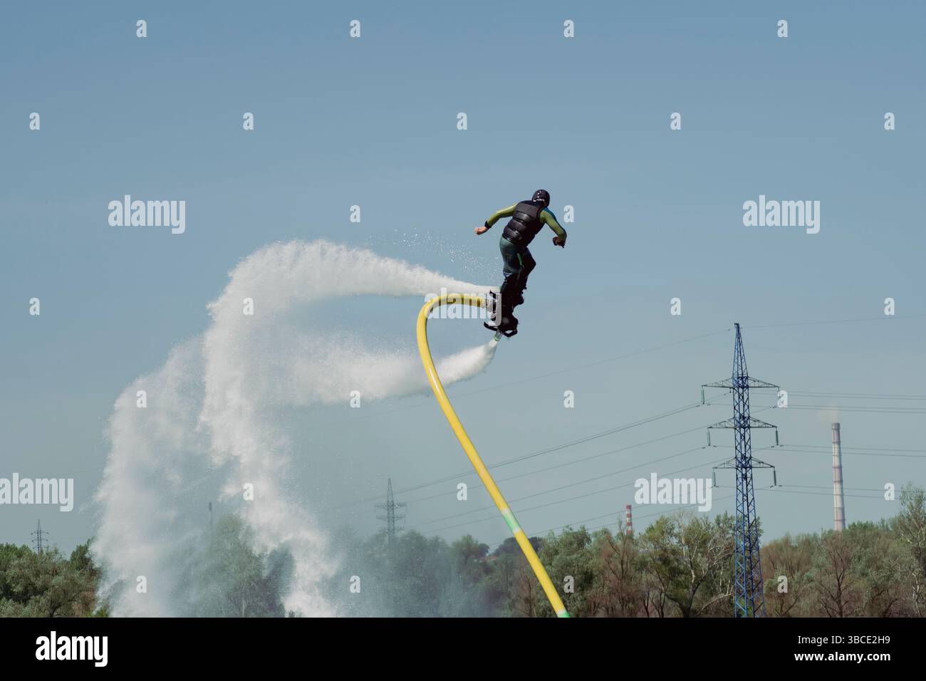 A man performs dangerous stunts on the water. flying with a flyboard ...