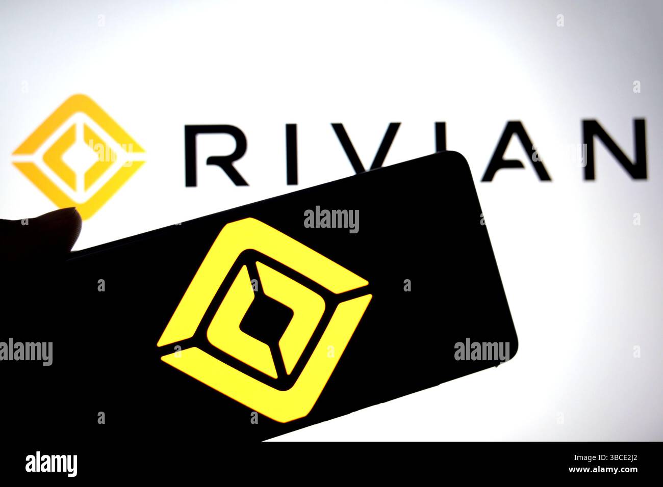 India. 18th May, 2025. In this photo illustration, a Rivian logo is ...