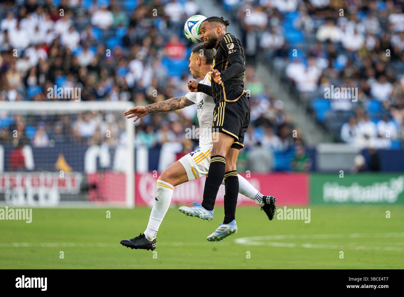 LAFC defender Eddie Segura (4)wins a header against LA Galaxy forward ...