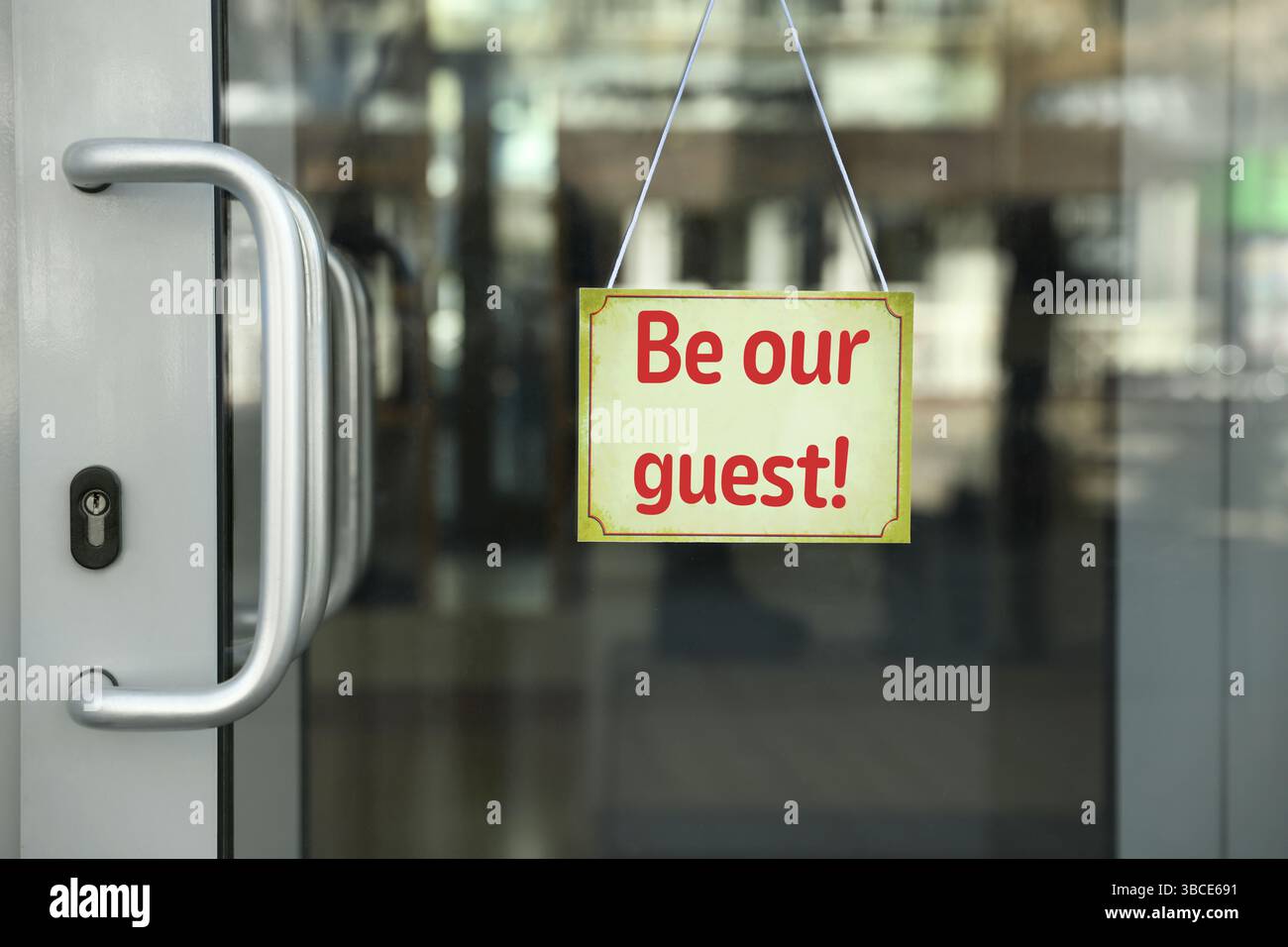 Be Our Guest sign hanging on glass door outdoors Stock Photo - Alamy