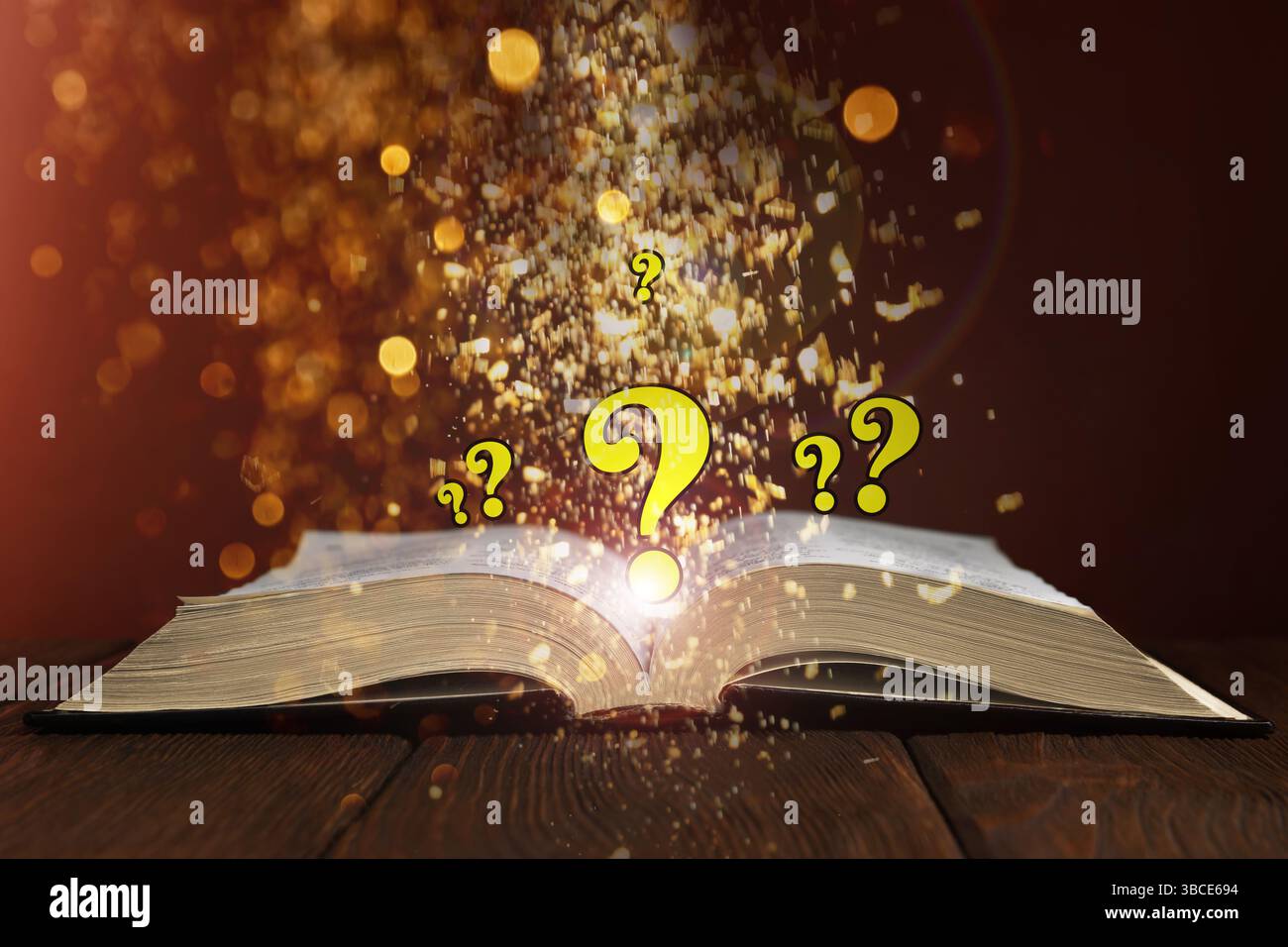 Question marks and magic lights flying out of open book on table ...